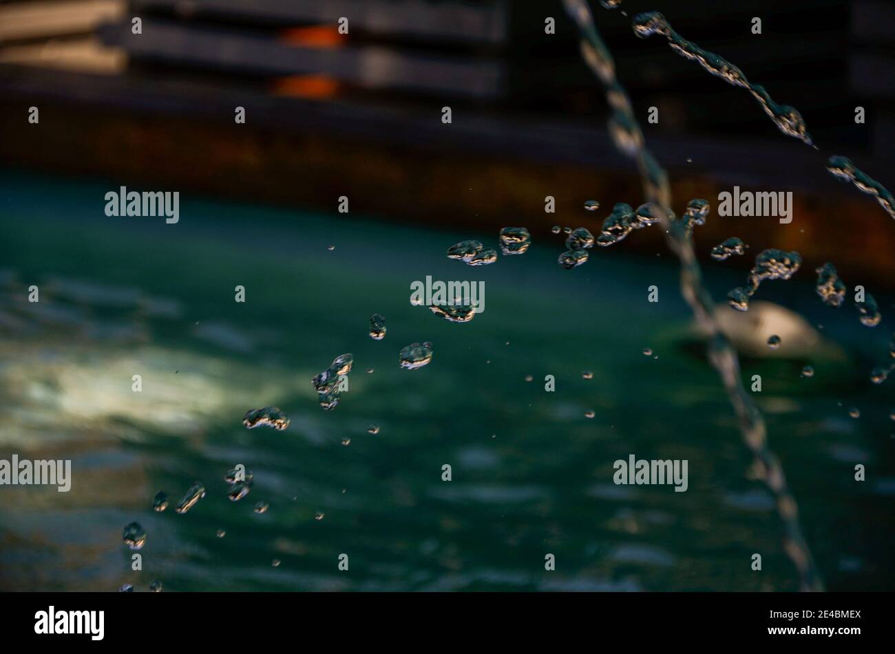 Water drops spread above fountain. This picture is taken in a split of ...