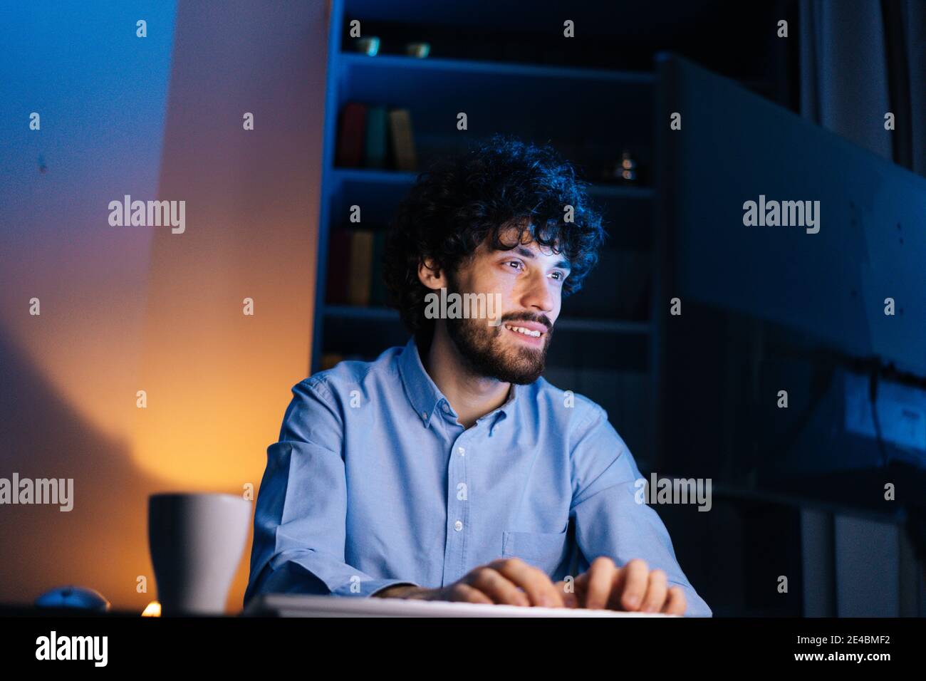 Close-up face of happy smiling bearded young man looking intently at ...