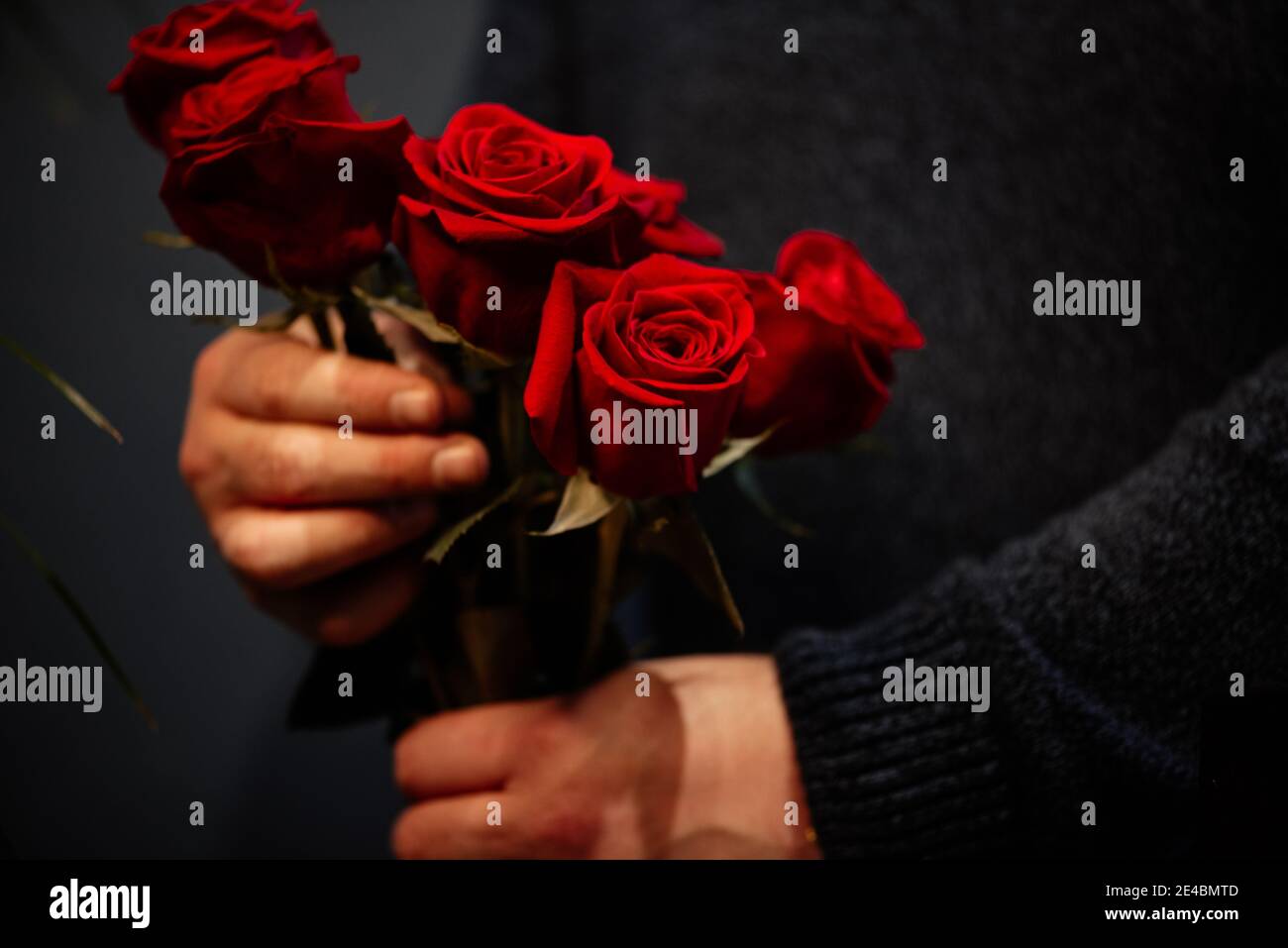 Caucasian florist selling bouquets of red and pink roses for valentine ...
