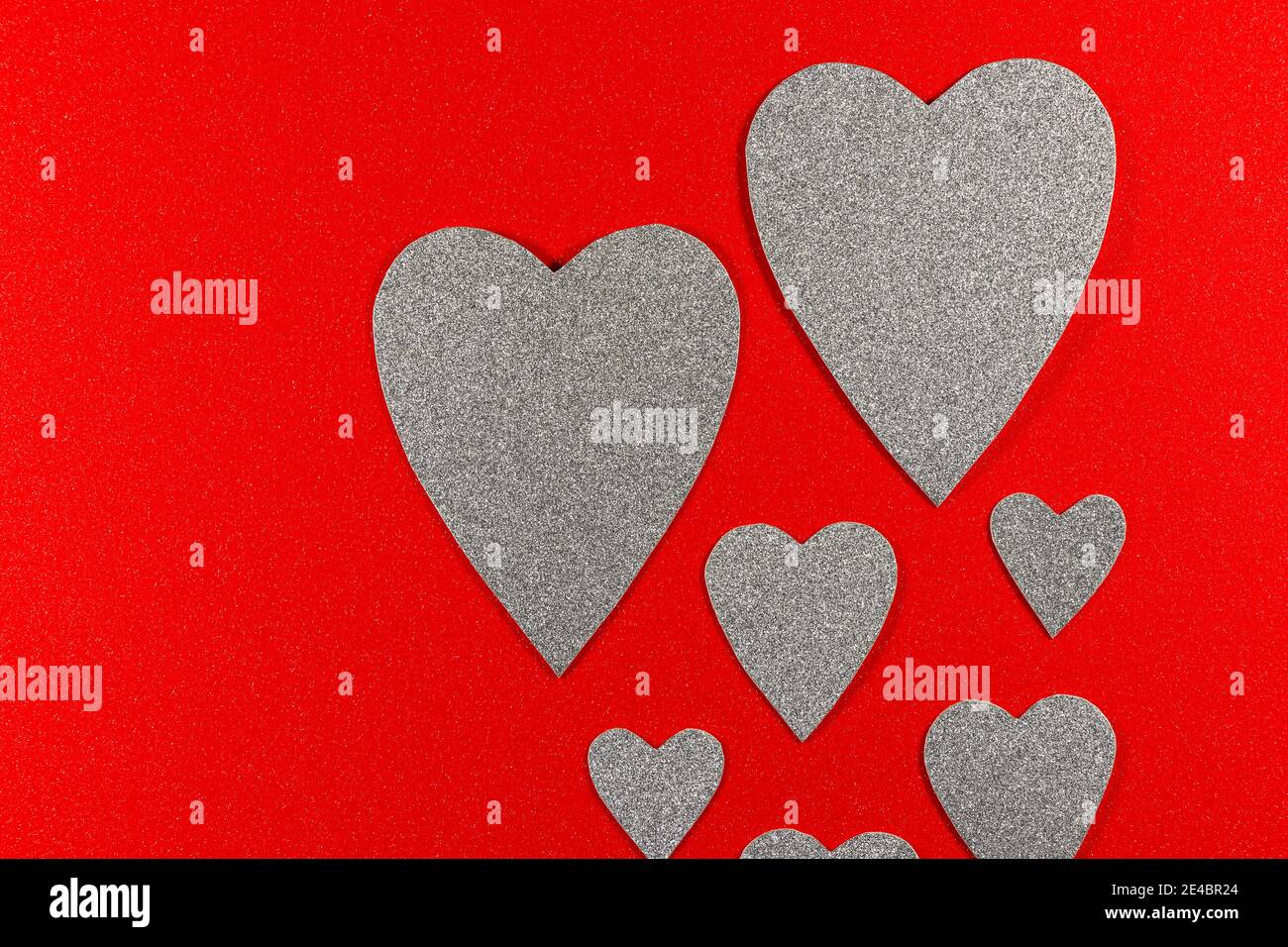Silver Hearts Rising On Red Textured Background Stock Photo - Alamy