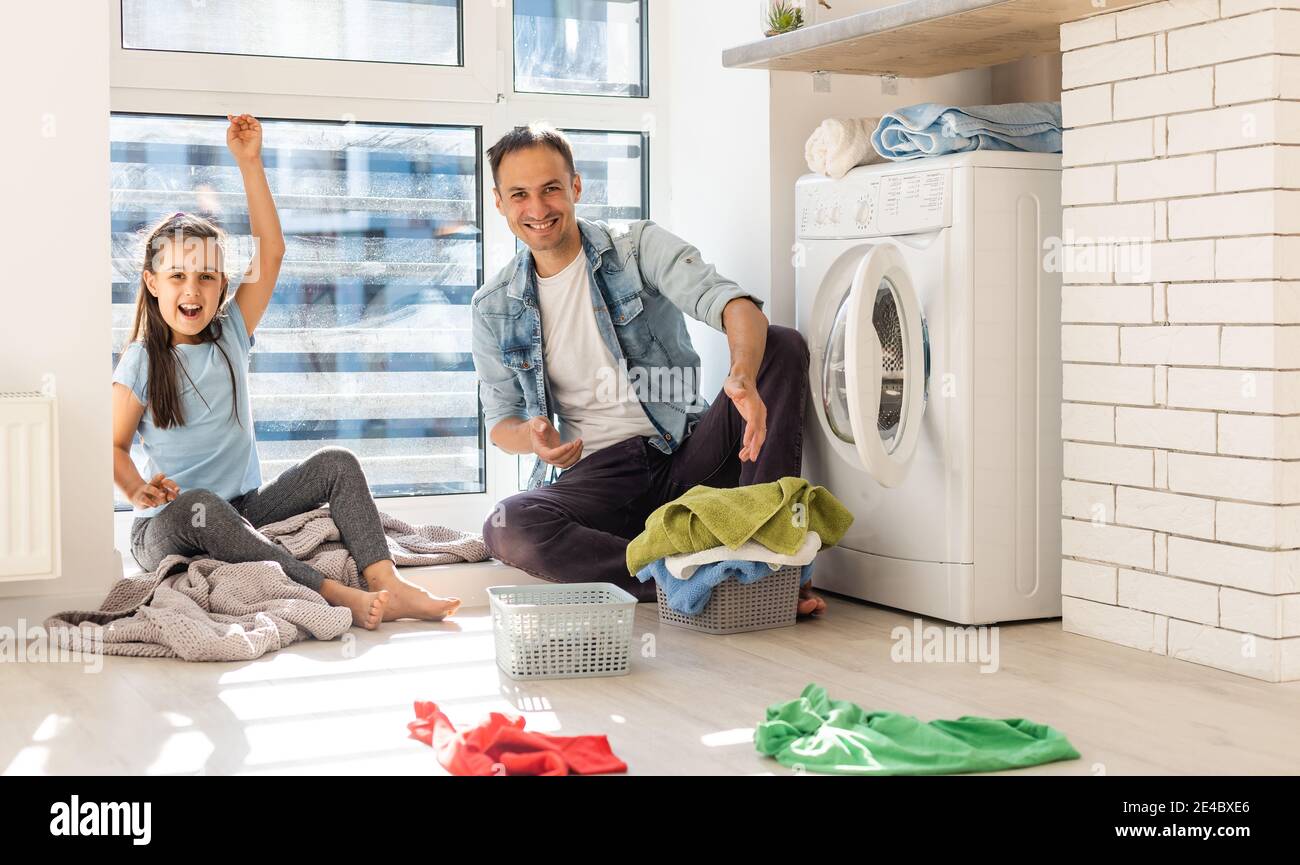 happy casual multiethnic family laundry clothes at home Stock Photo - Alamy