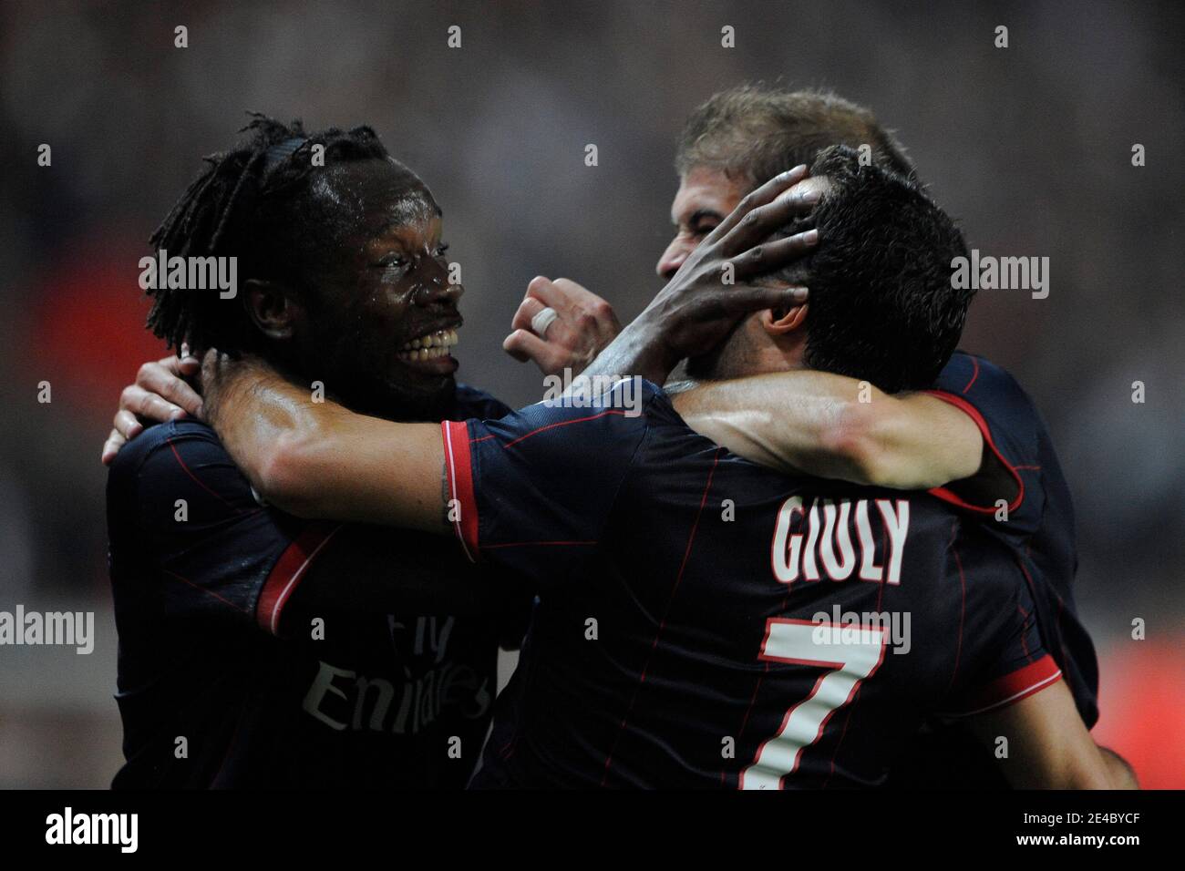 PSG's Ludovic Giuly celebrates with his team mates after scoring during ...