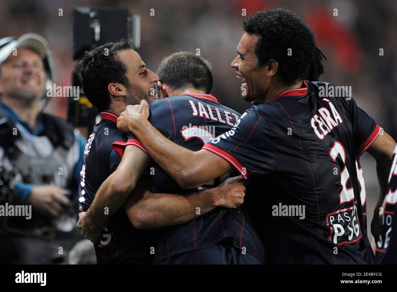 PSG's Ludovic Giuly celebrates with his team mates after scoring during ...
