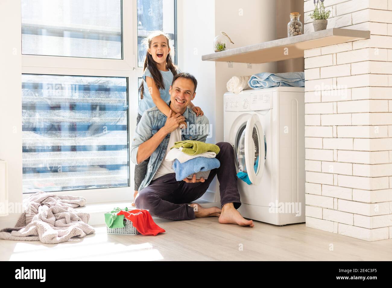 happy casual multiethnic family laundry clothes at home Stock Photo - Alamy