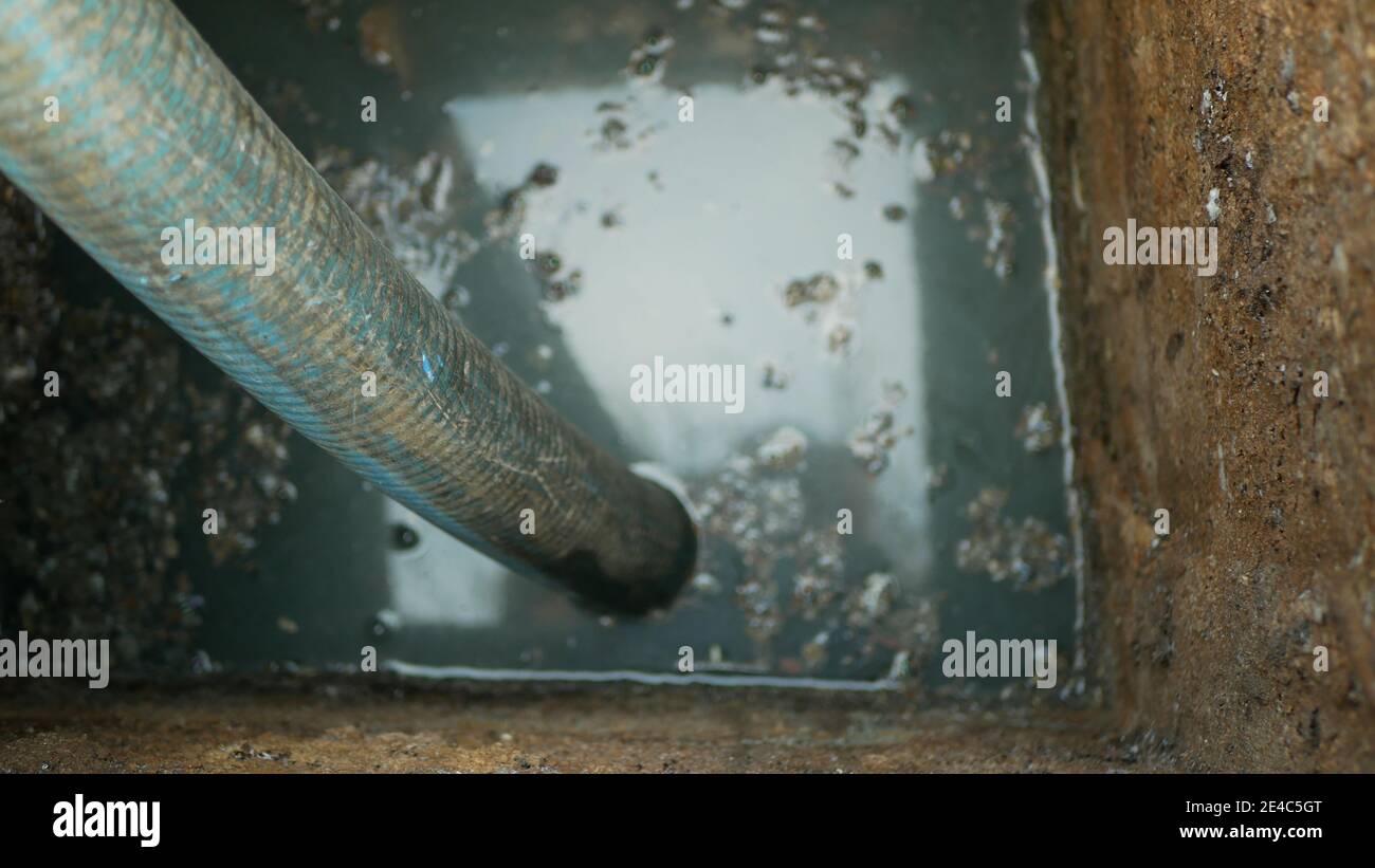 Septic cesspool pumping into tank by suction hose under high pressure ...