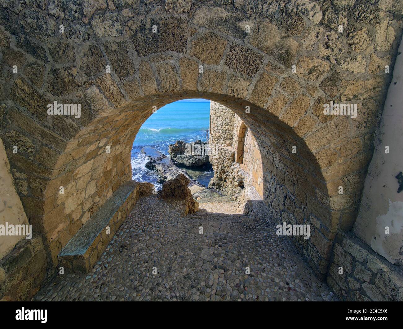 Stone bridge between houses with passage to the sea in the fishing ...
