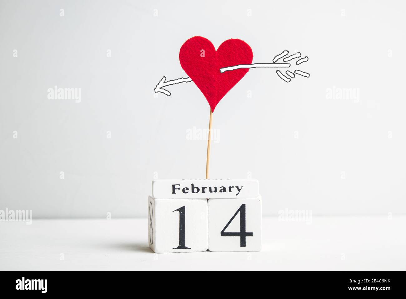 February 14 concept with heart on stick and arrow Stock Photo - Alamy