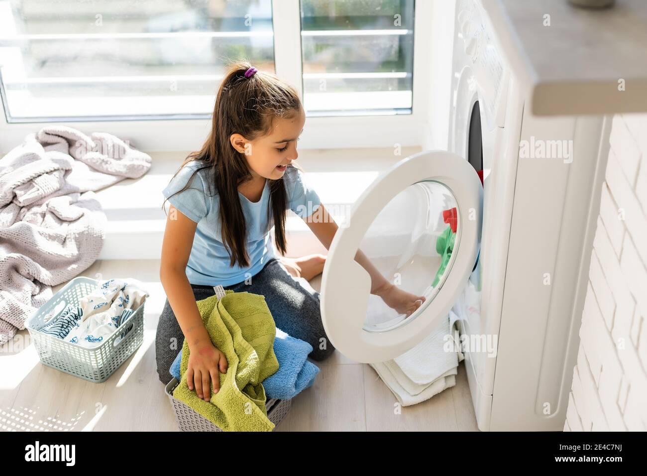Beautiful child girl little helper is having fun and playing while ...