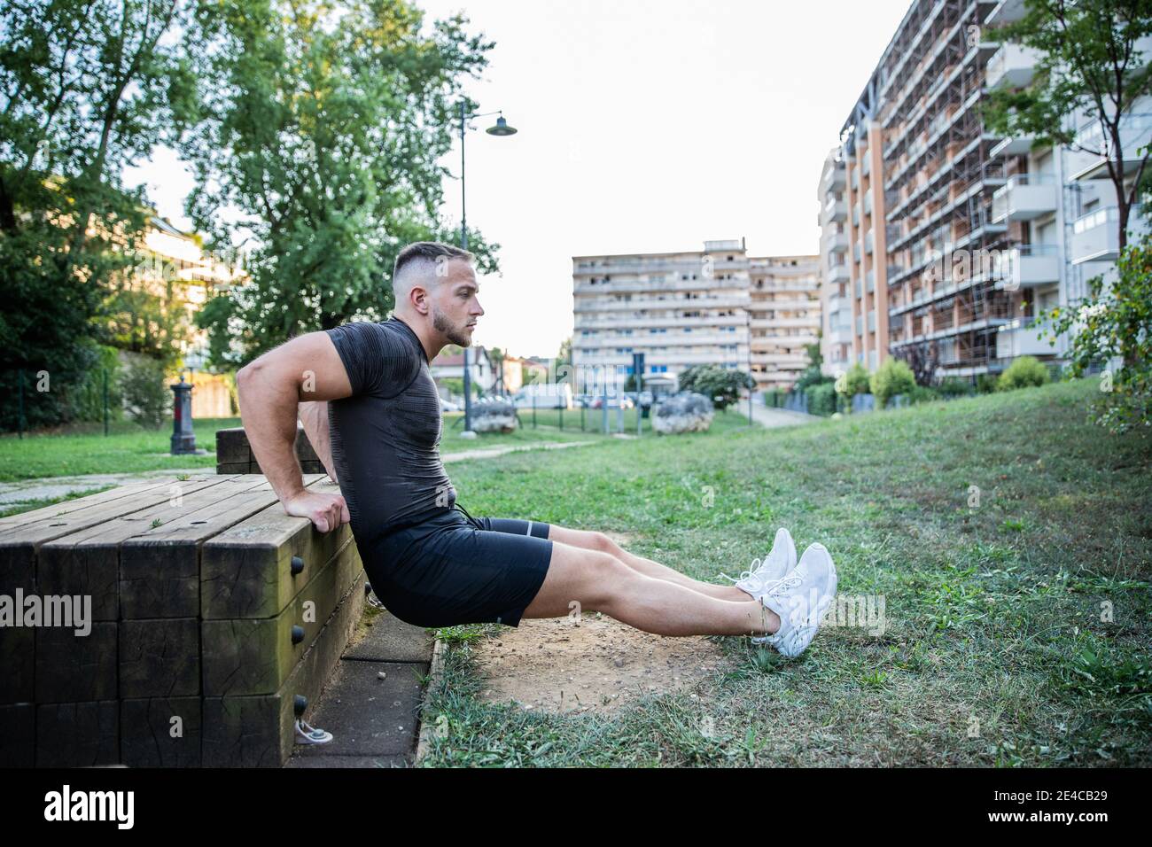 A young caucasian boy performs various muscle training and stretching ...