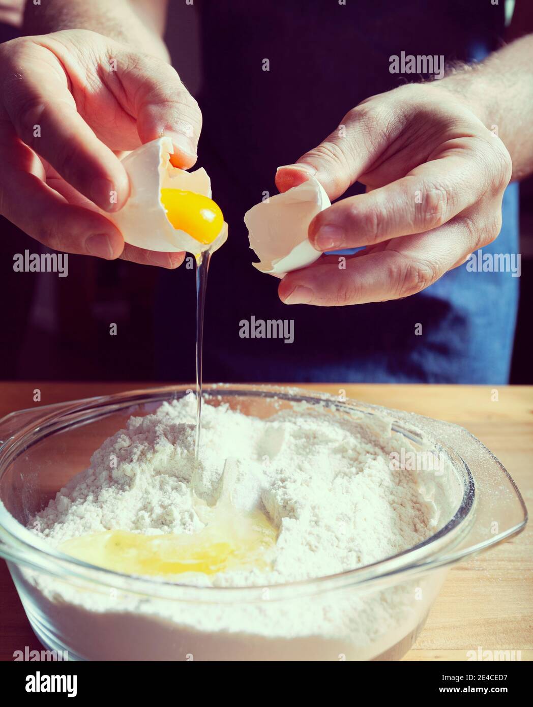 Making the dough adding eggs to the flour.Cooking process Stock Photo ...