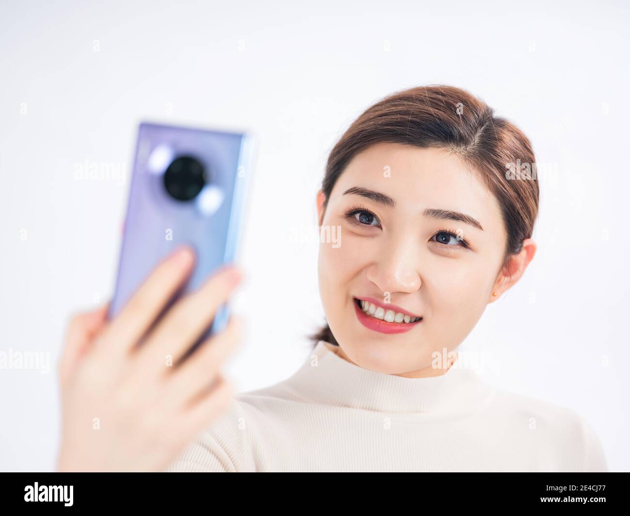 Young smiling women take self portraits with mobile phone Stock Photo ...