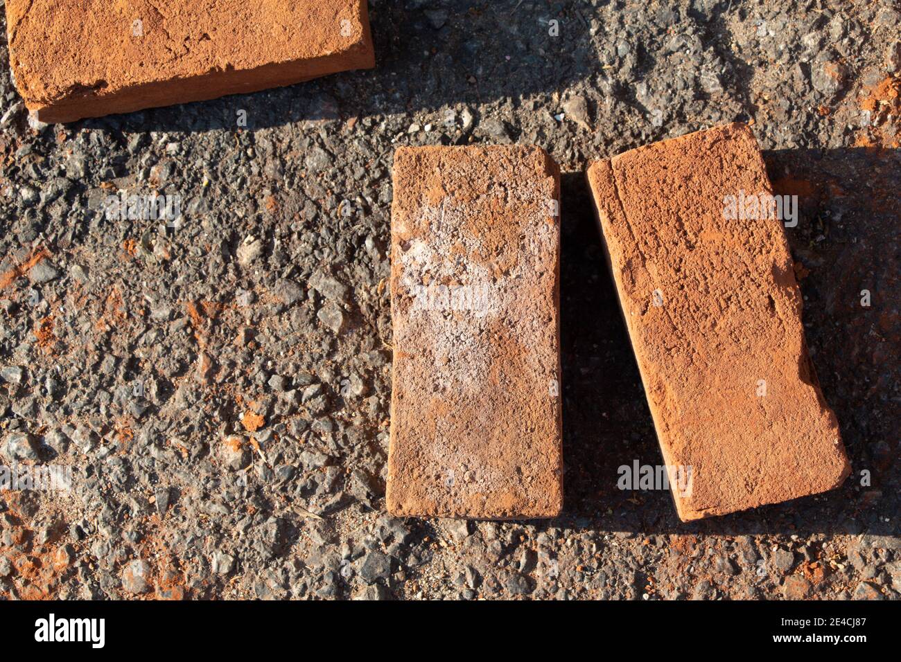 Top view of three old bricks on a concrete surface Stock Photo - Alamy