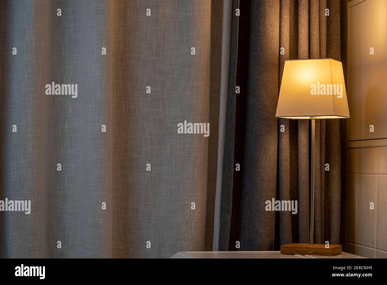 Lamp stands in front of a gray curtain hi-res stock photography and ...