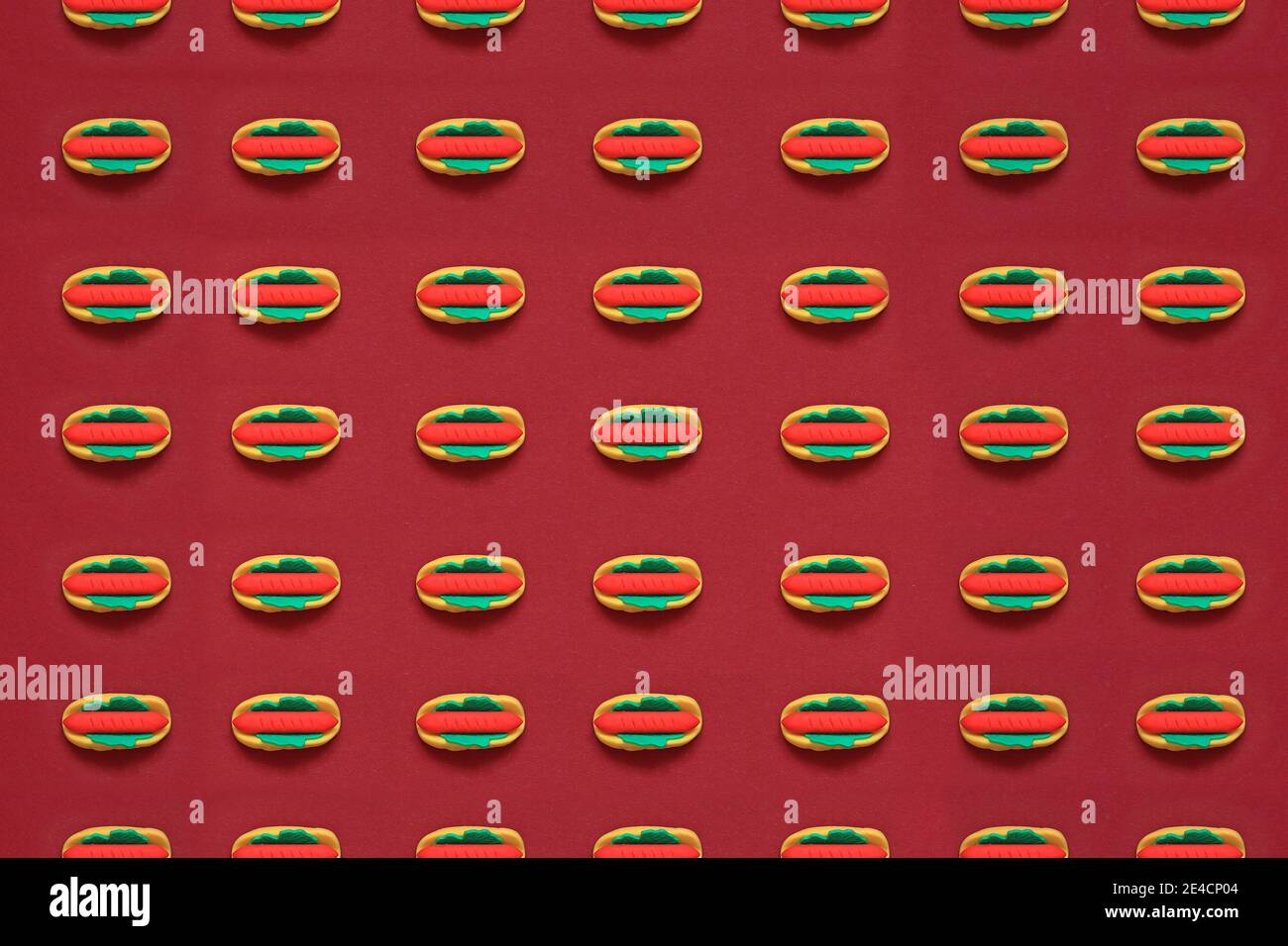 Many small hot dogs on a red background. Fast food. Wallpaper Stock ...