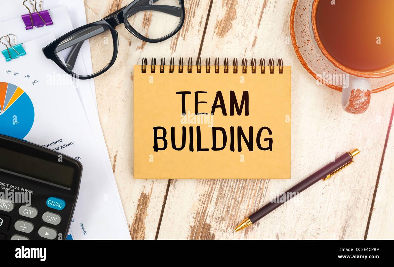 Team Building is written on a notepad on an office desk with office ...