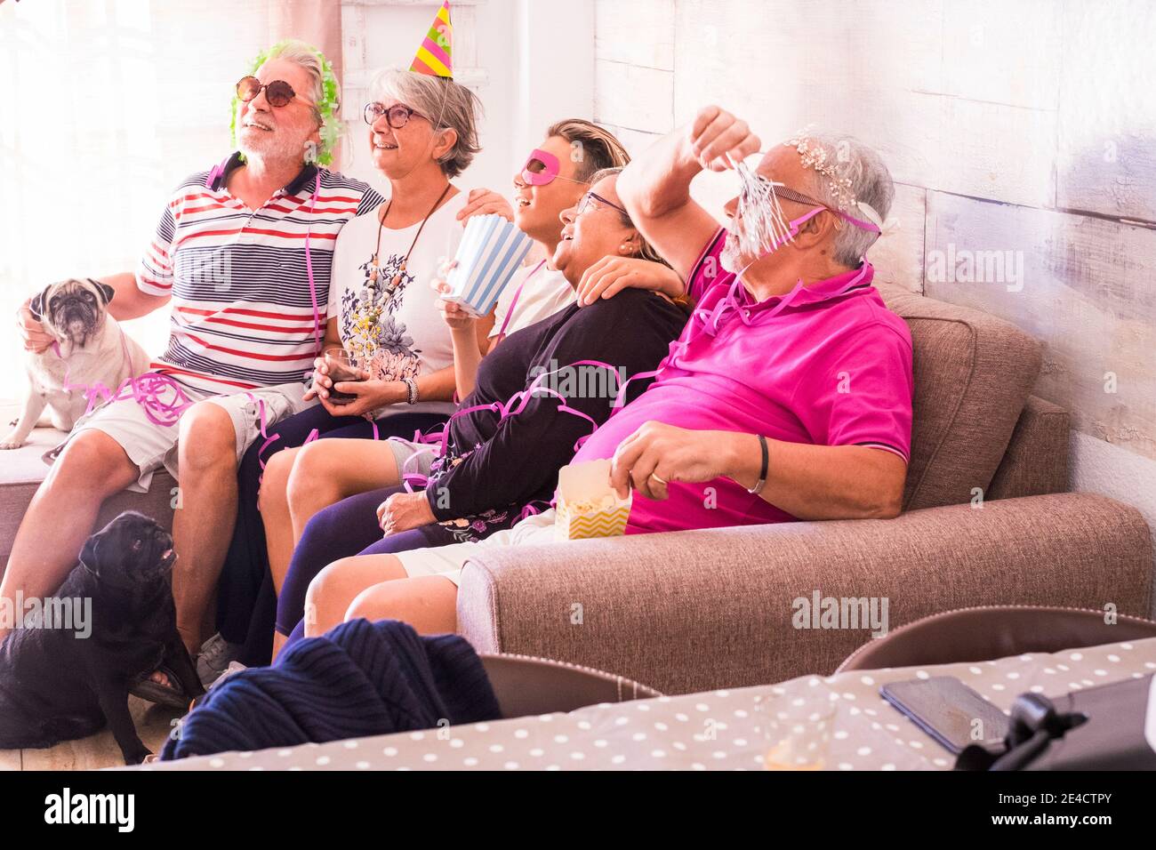 Family group of mixed ages generations celebrate together at home with ...