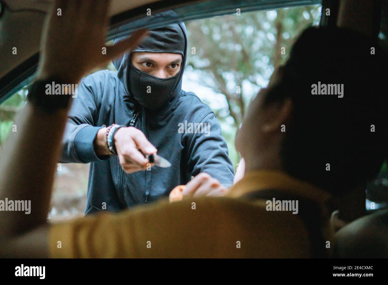 Bandit man with masked robber holding knife to hijack hostage man ...