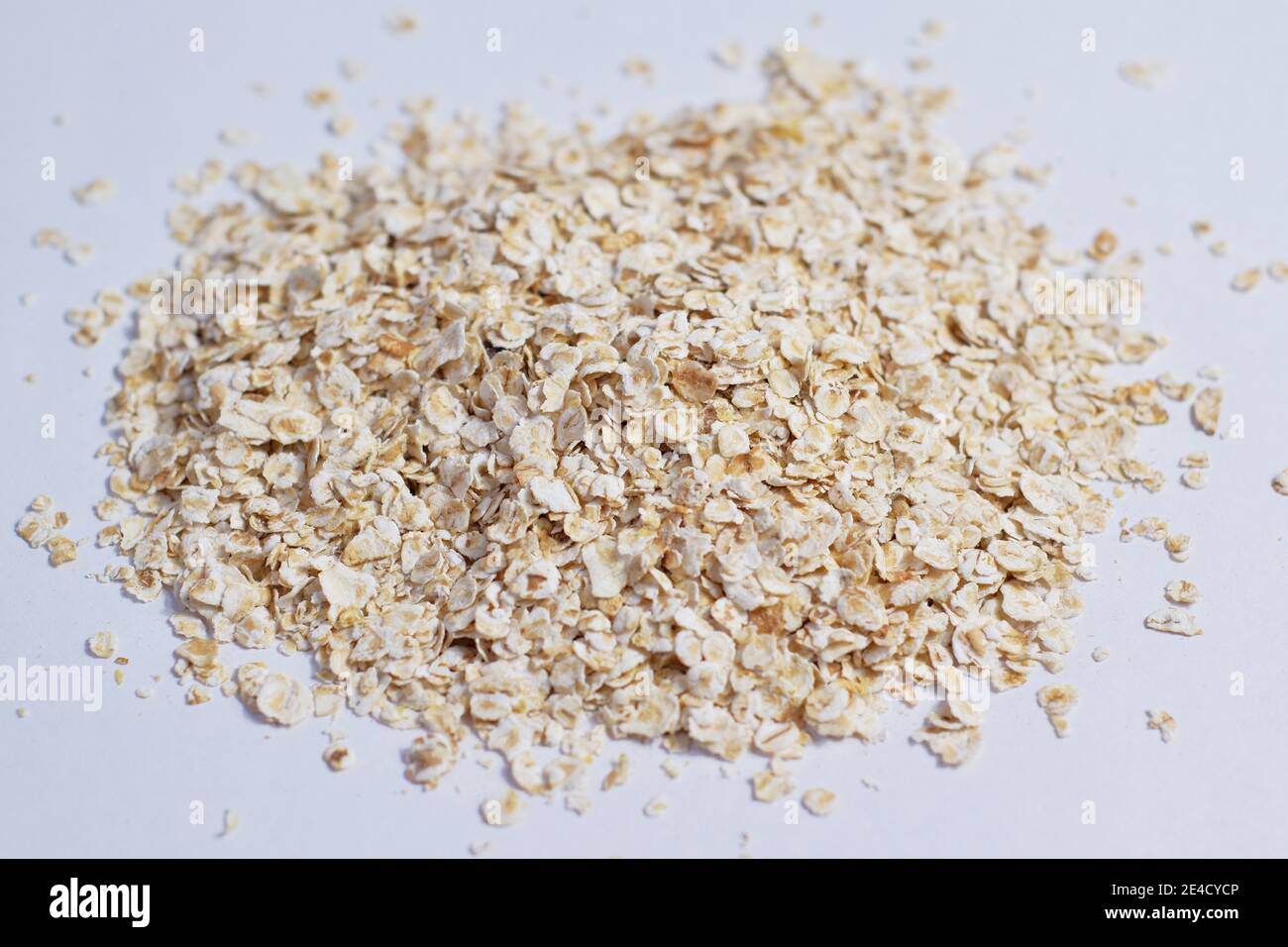 Pile oatmeal flakes scattered on a white background Stock Photo - Alamy