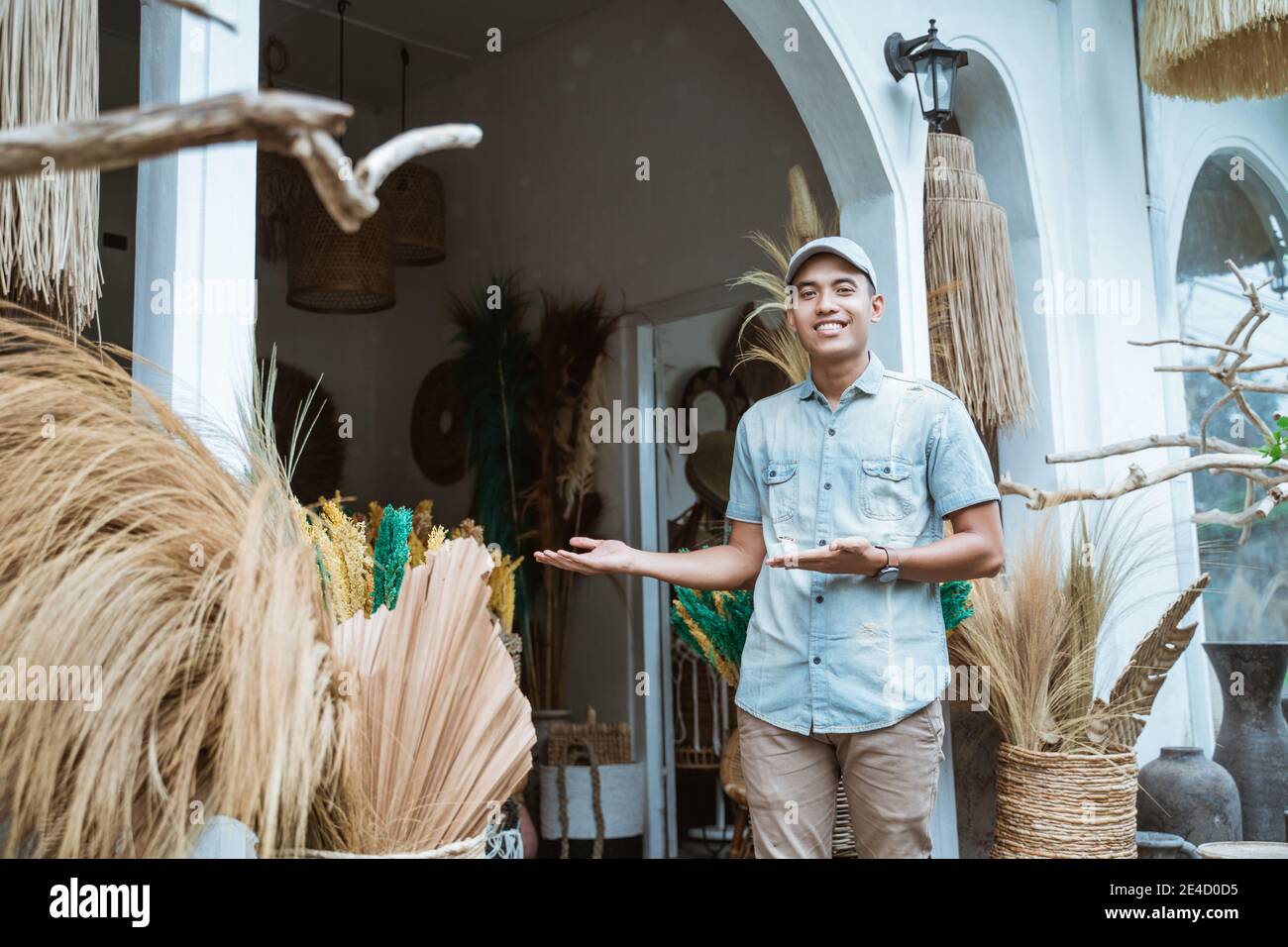 handicraft business owner with a hand gesture presents something in ...