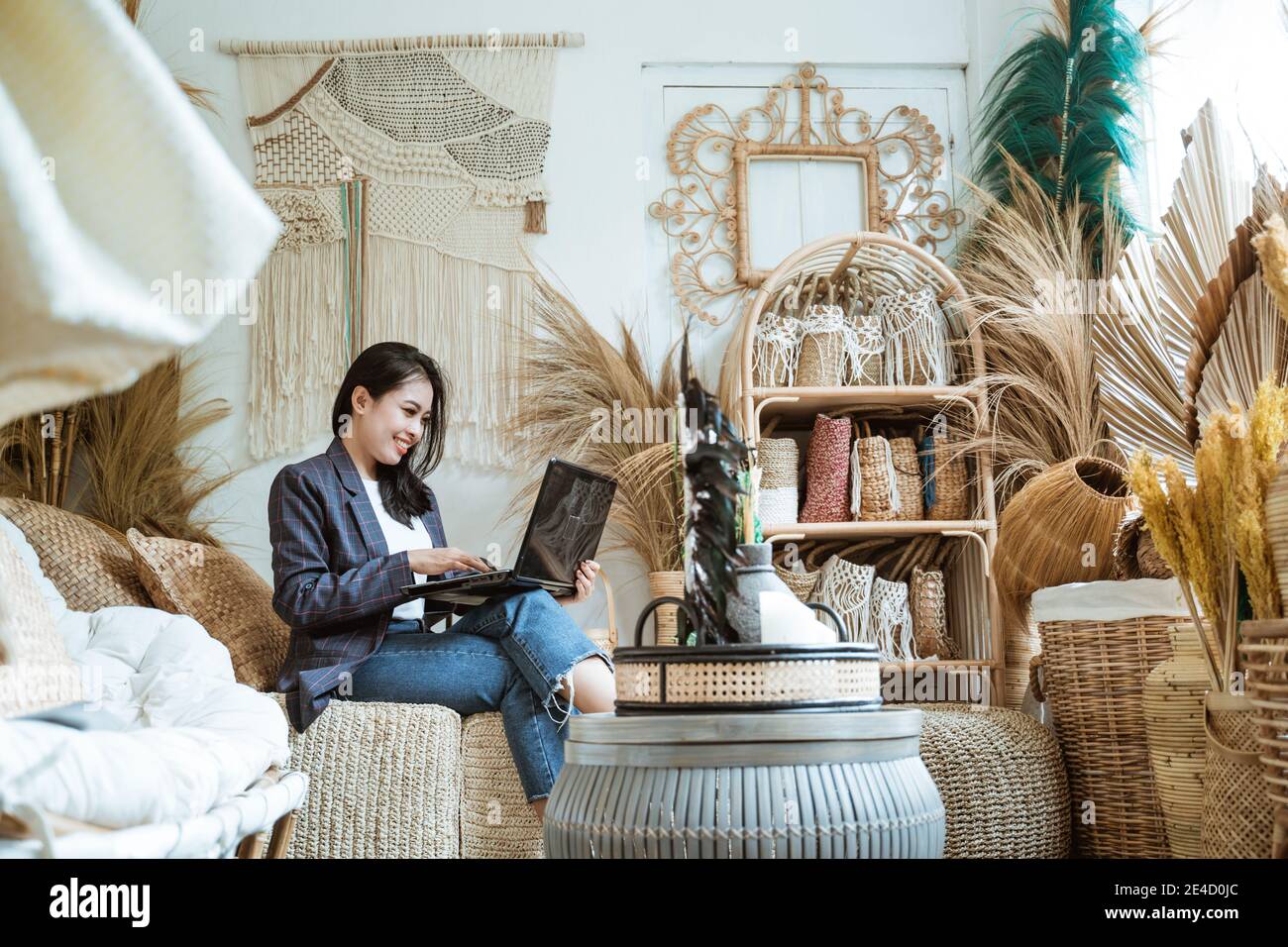 beautiful woman smiling using a laptop computer in a handicraft ...