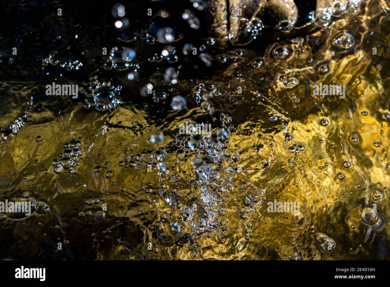 Droplets hitting water surface with appearance of being underwater ...