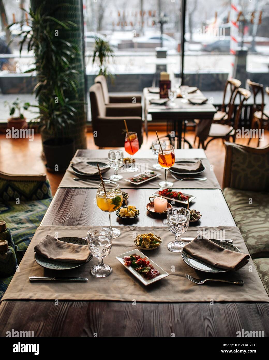 Served table with aperitif cocktails and appetizer Stock Photo - Alamy