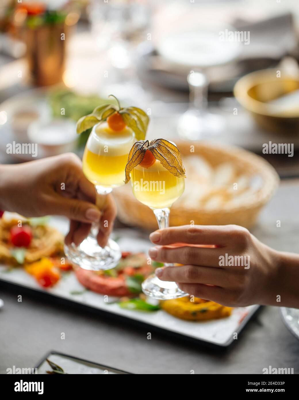 Clinking shot glasses of sour foamy cocktails Stock Photo - Alamy