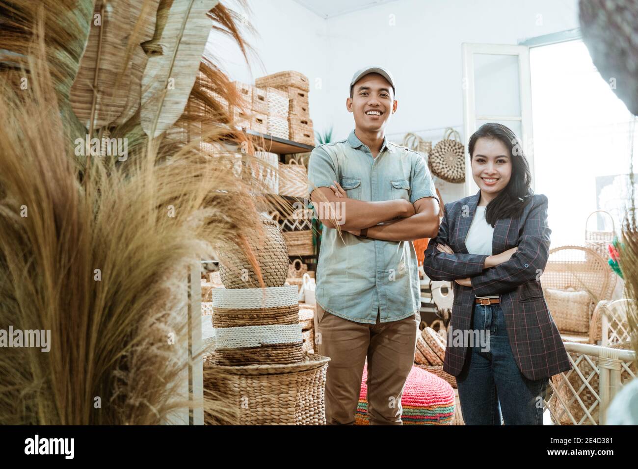 craft businessman and woman with crossed hands while in a craft shop ...