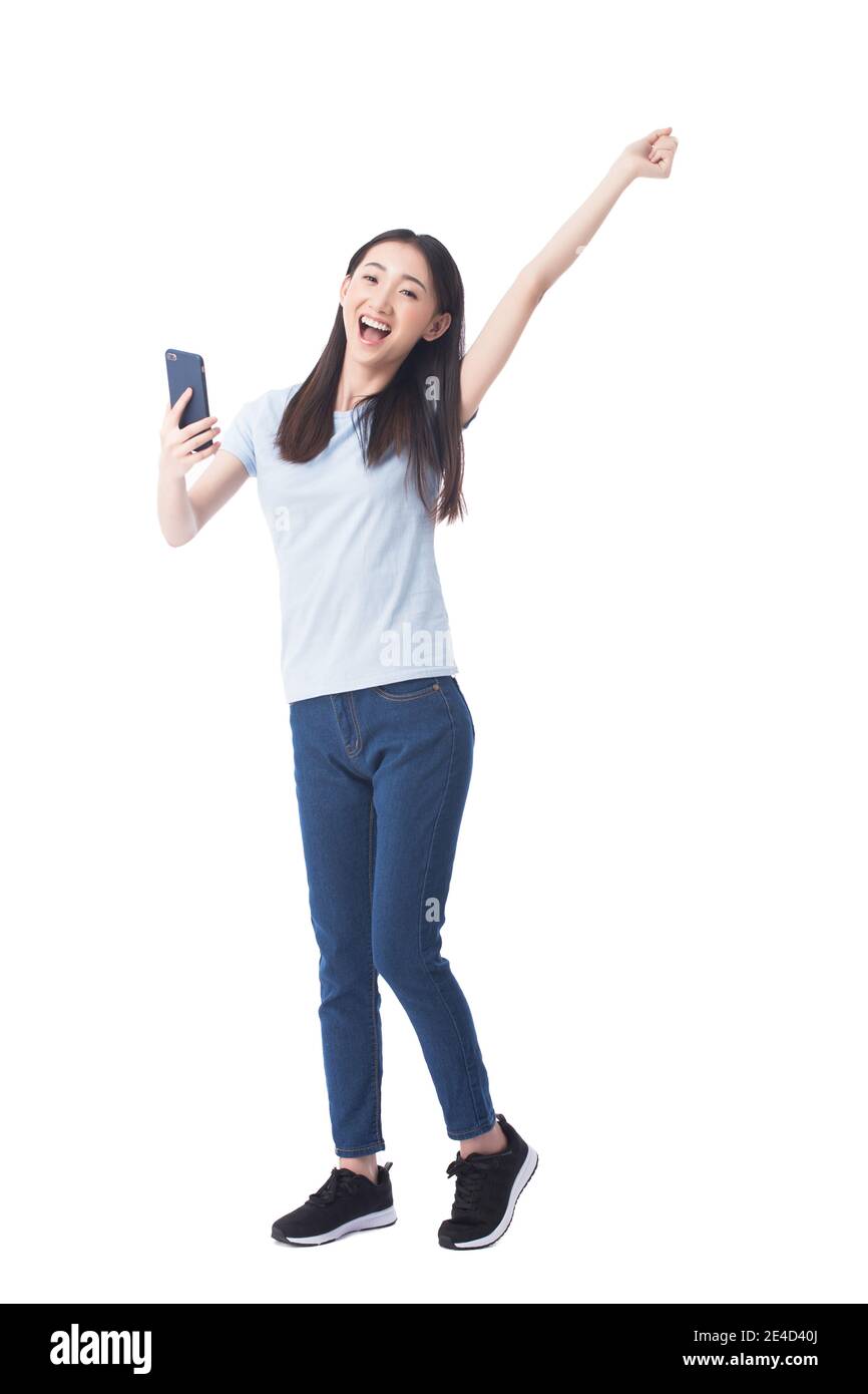 Girl standing aginst white background Stock Photo - Alamy