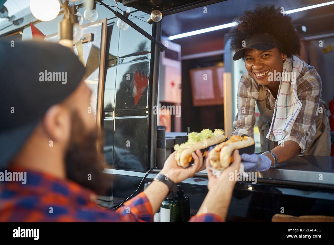beautiful young afro-american female employee looking at camera ...