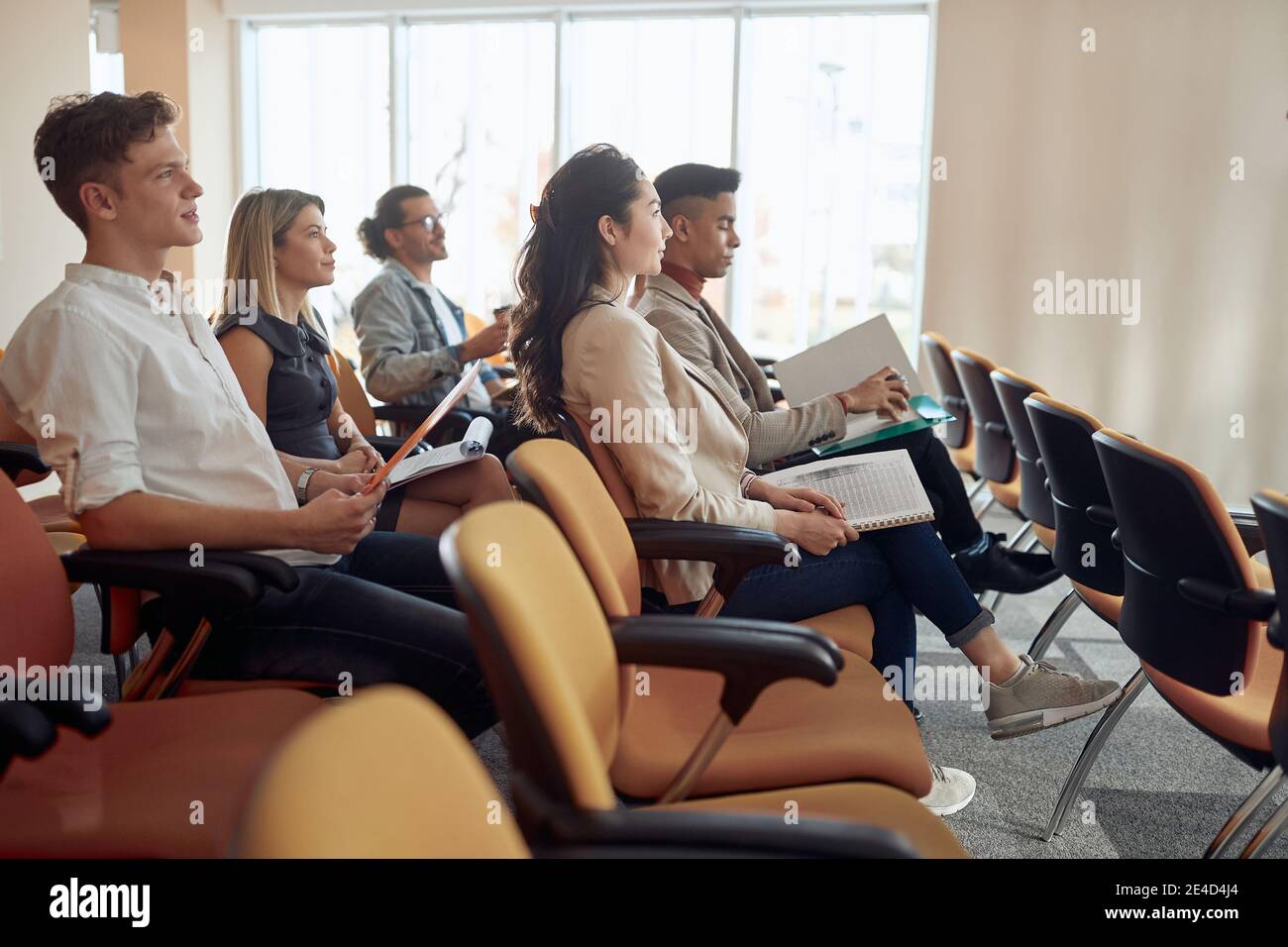 group of young multiethnic people listening lecture at business seminar ...