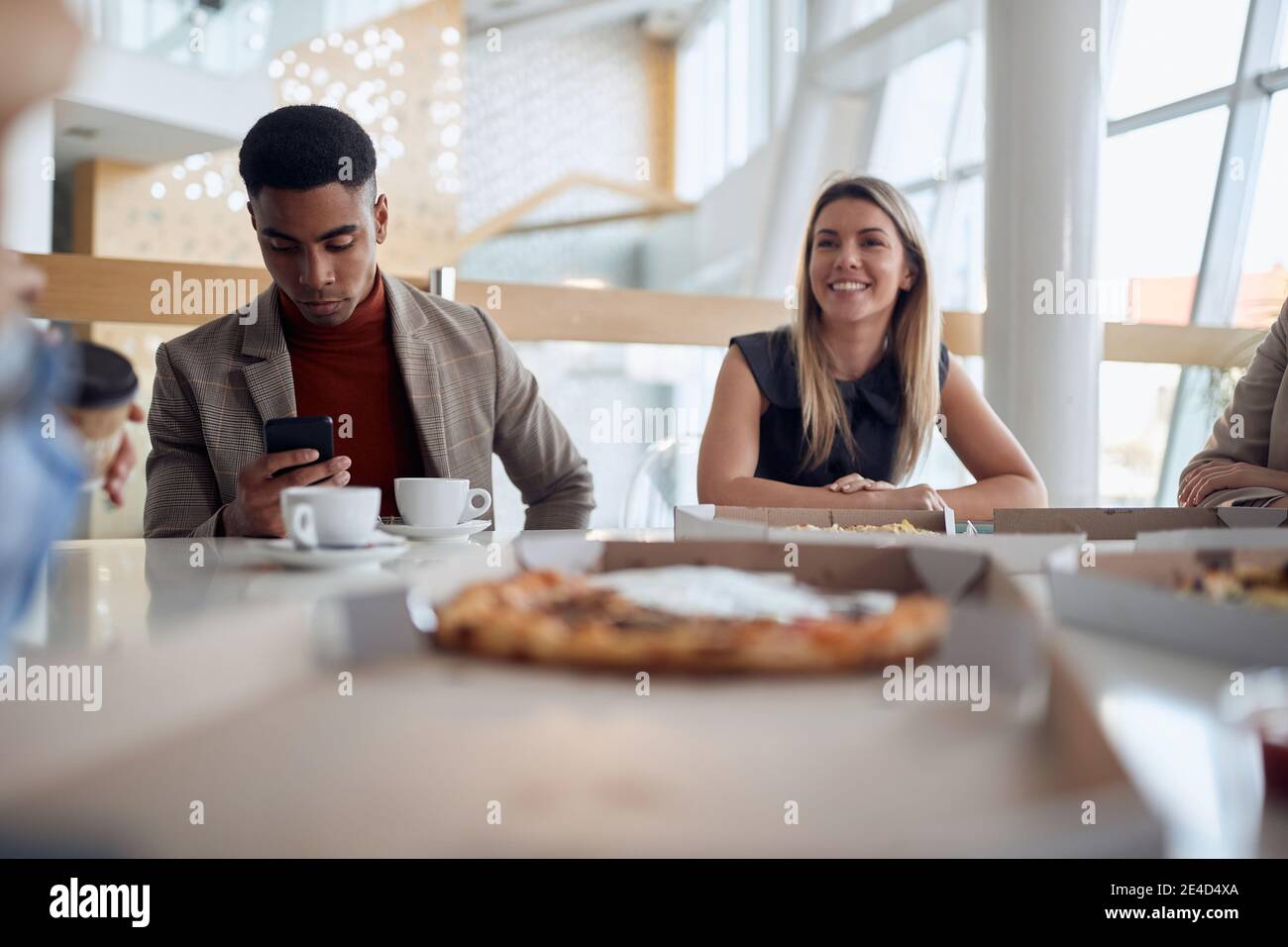 young business people at break, drinking coffee after fast food lunch ...