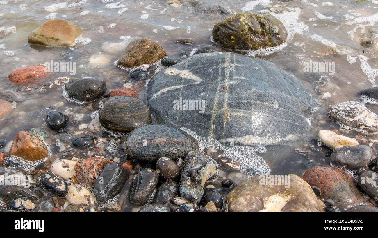 Waves and stones at a lovely beach in Denmark Stock Photo - Alamy