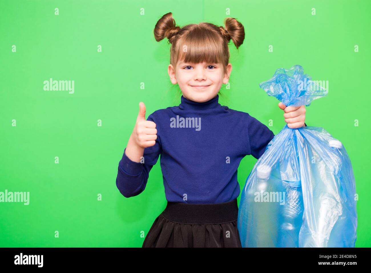Happy little girl holding garbage bag with plastic trash and showing ...