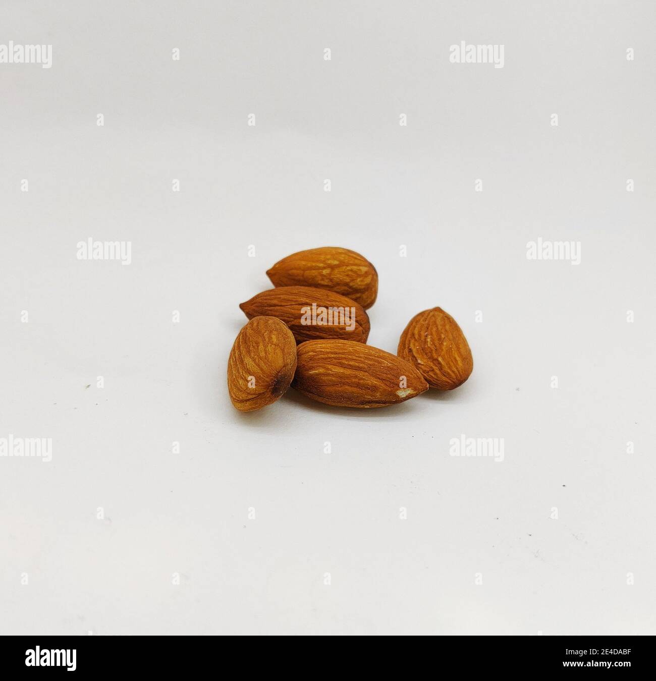 Fresh almonds on a white background Stock Photo - Alamy