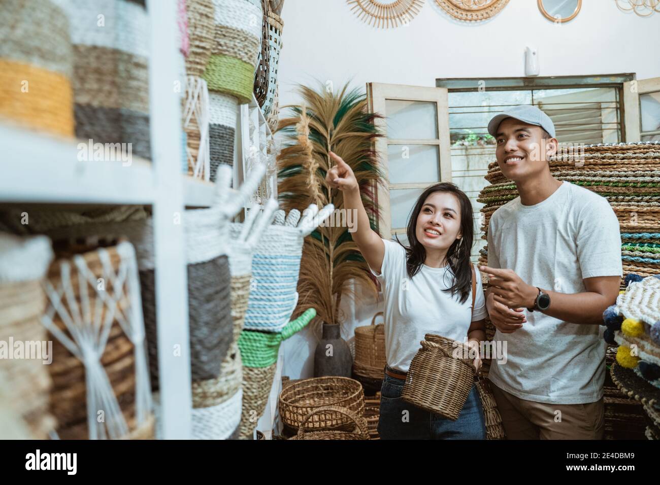 A couple viewing and selecting crafts with their finger pointing ...