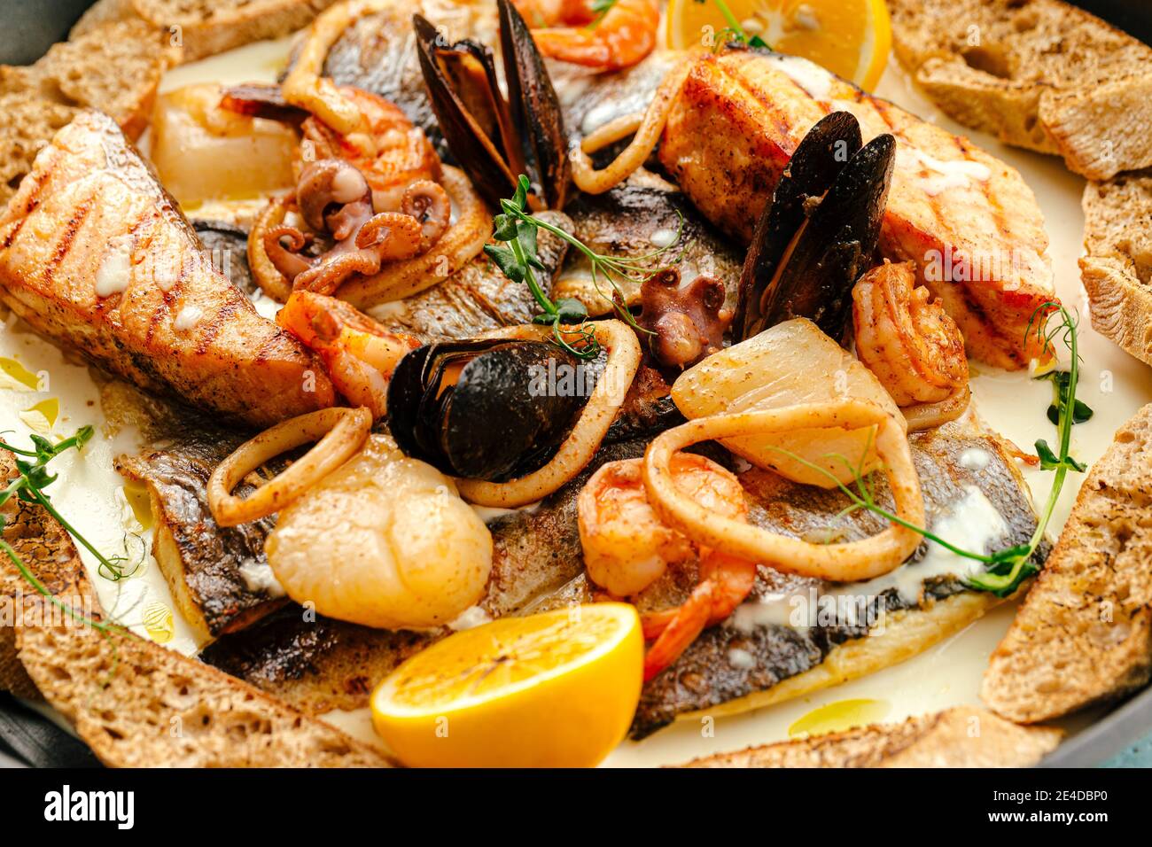 Closeup on seafood saute mix with cream sauce Stock Photo - Alamy