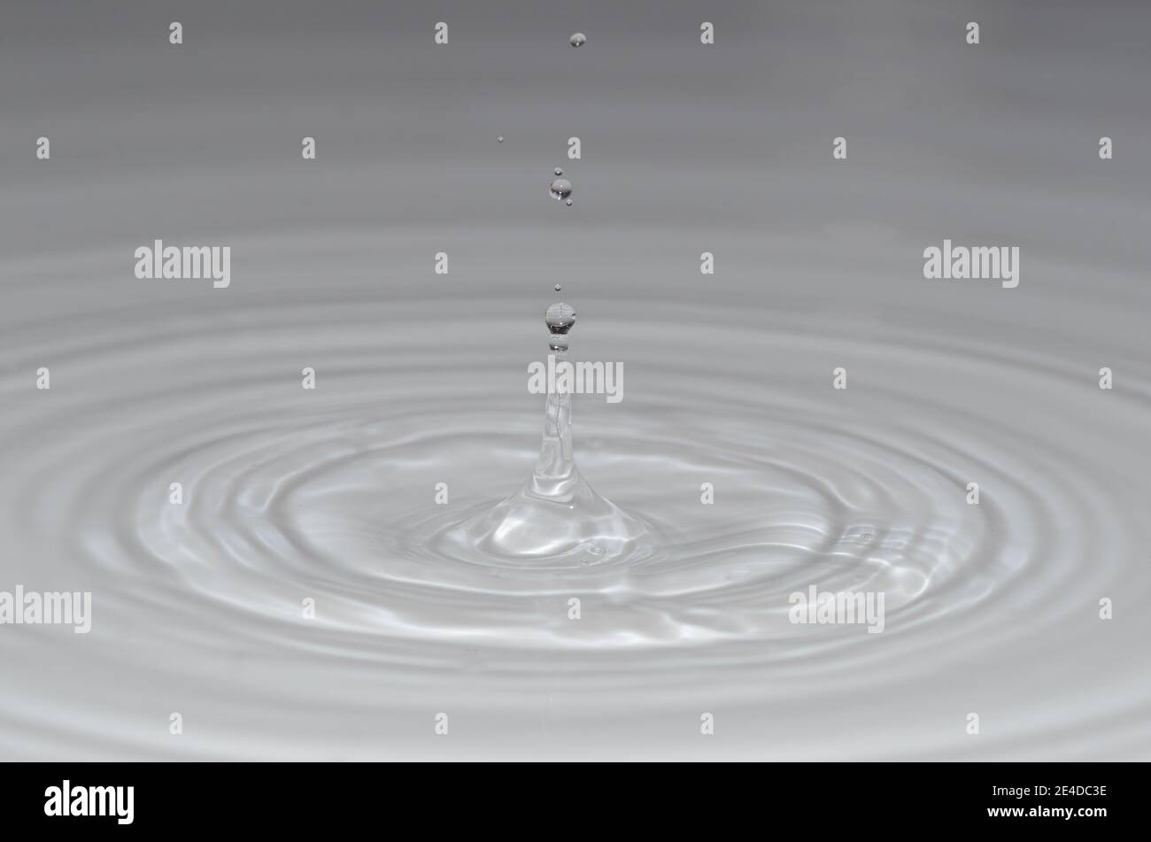 many small droplets on impact in the clear water Stock Photo - Alamy