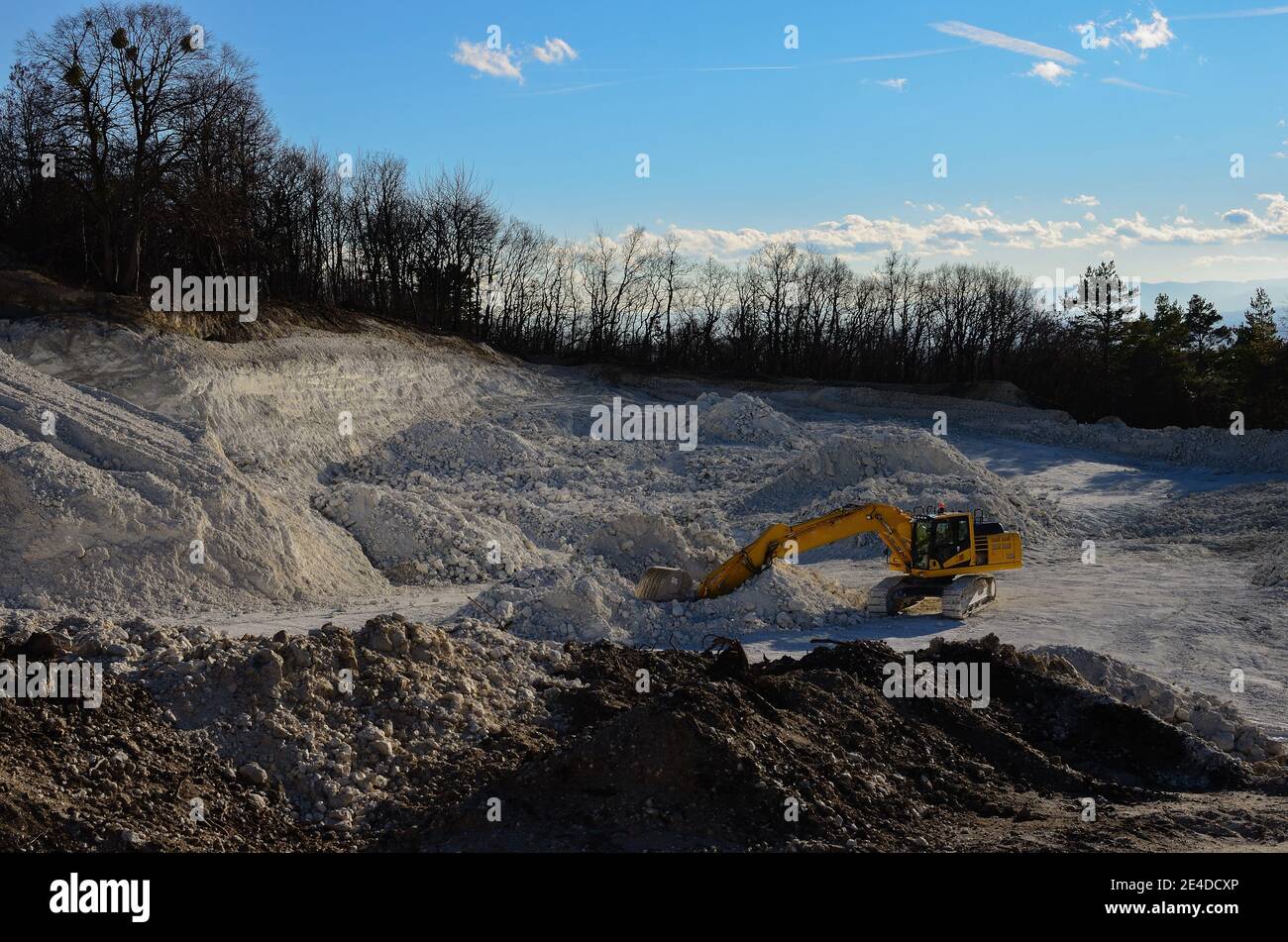great white limestone quarry and yellow excavators Stock Photo - Alamy