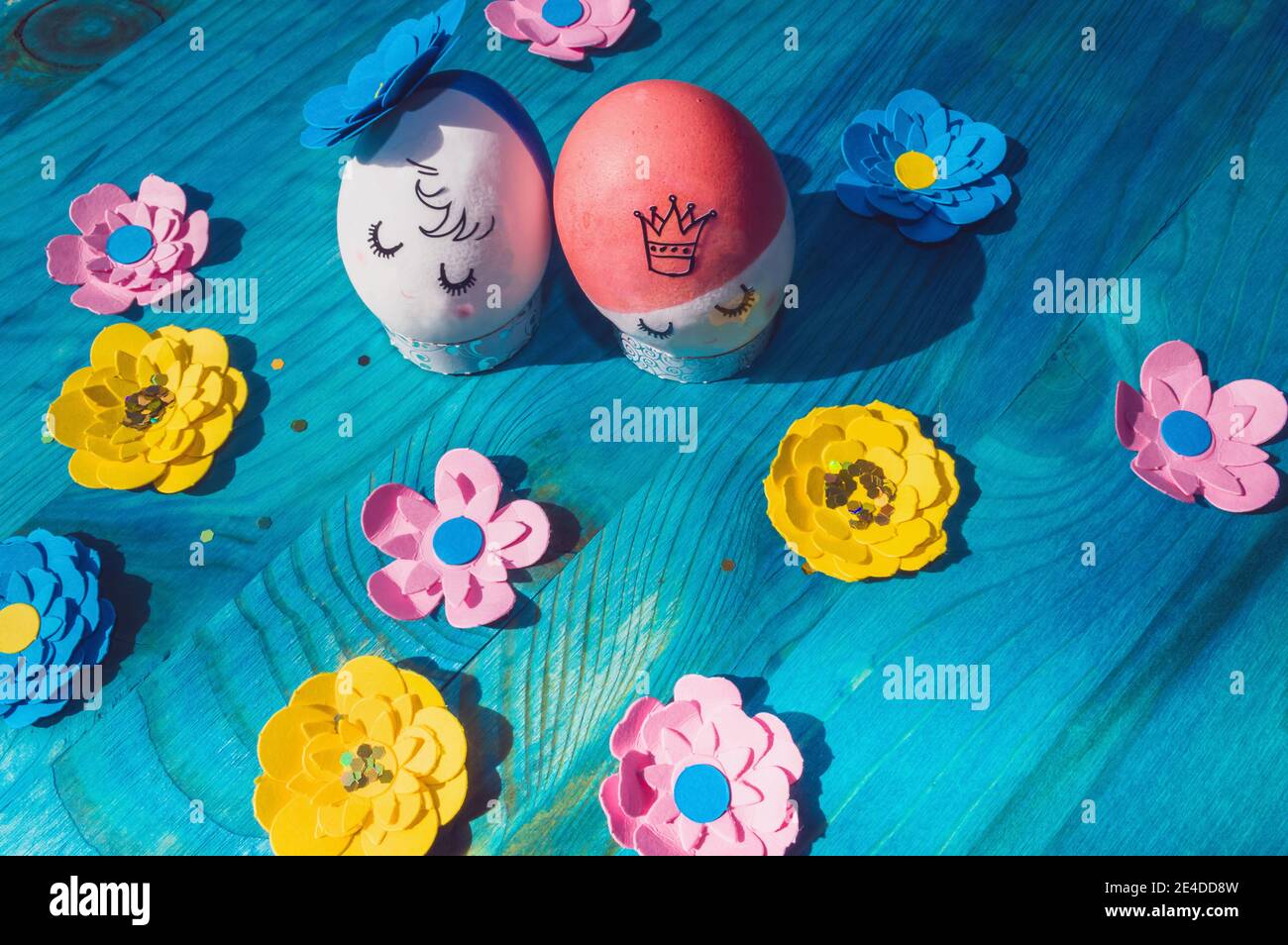 adorable couple of Easter eggs surrounded by paper flowers bathing in ...