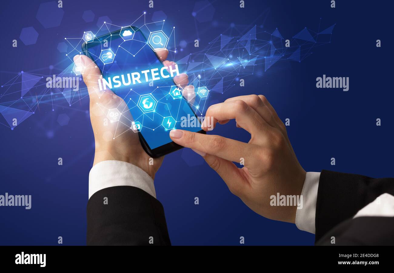 Female hand holding smartphone with INSURTECH inscription, modern ...