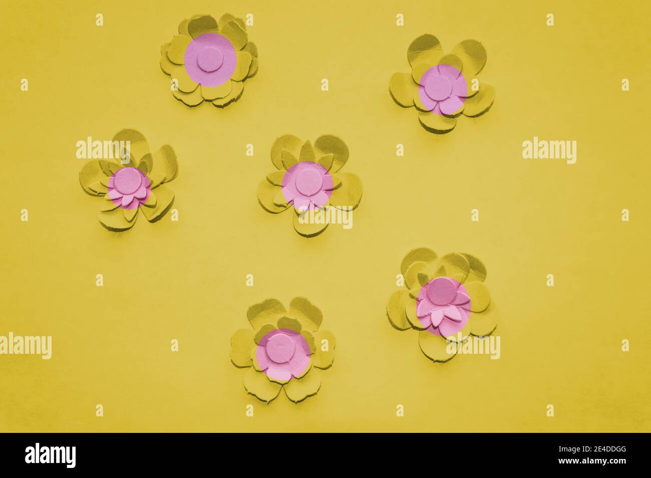 abstract background of yellow paper flowers with pink core and space ...