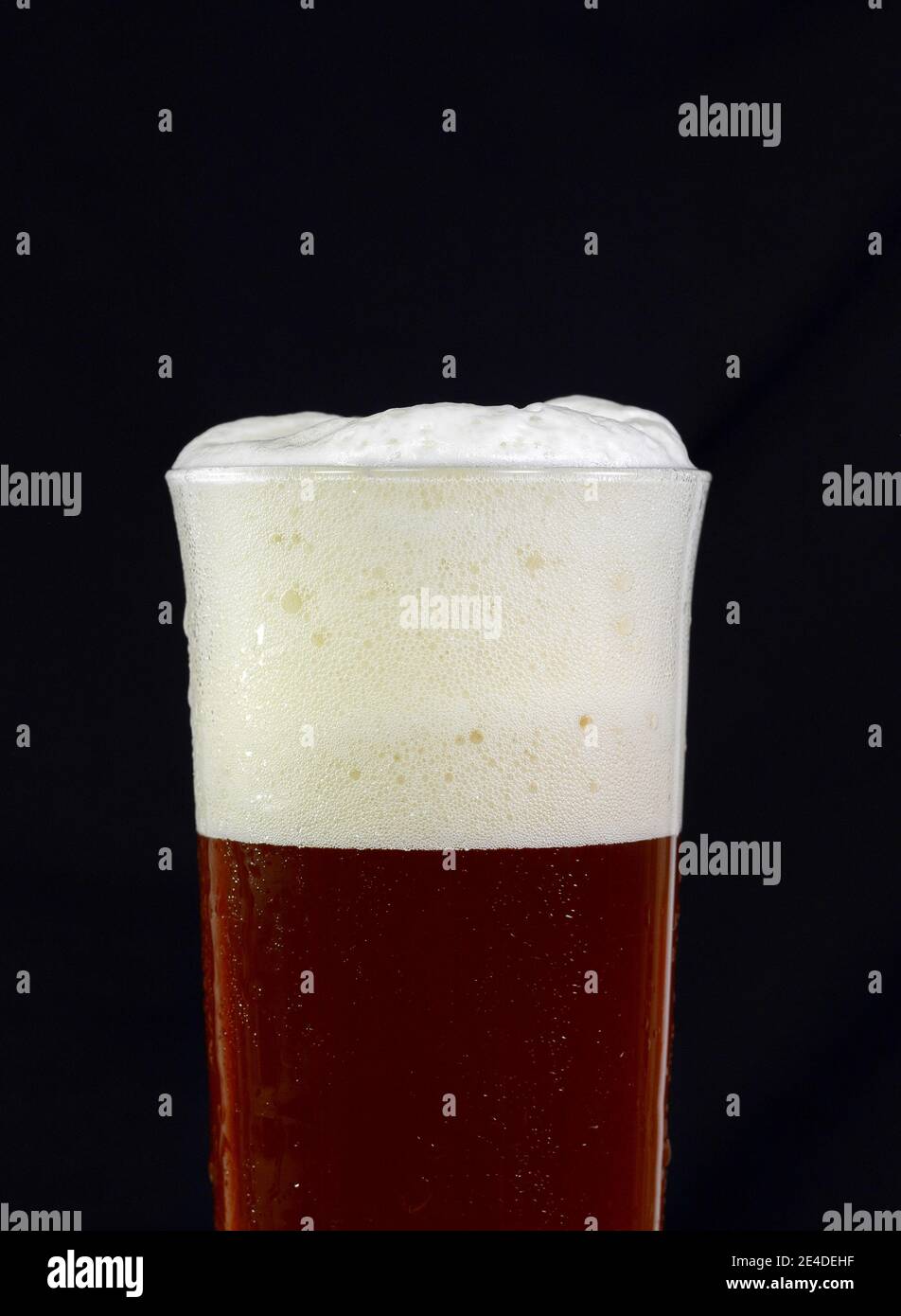 Irish red ale isolated on a black background Stock Photo - Alamy
