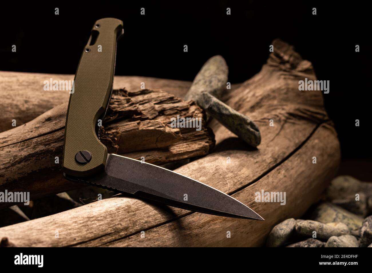The knife is in the folded position. Curved knife. Folding knife on a ...
