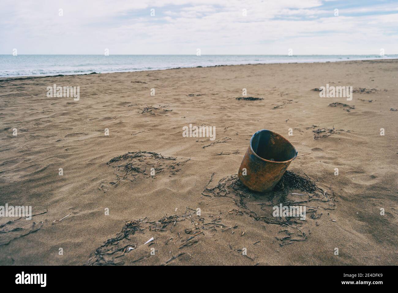 plastic pail washed up on a beach. You see the environmental problem ...