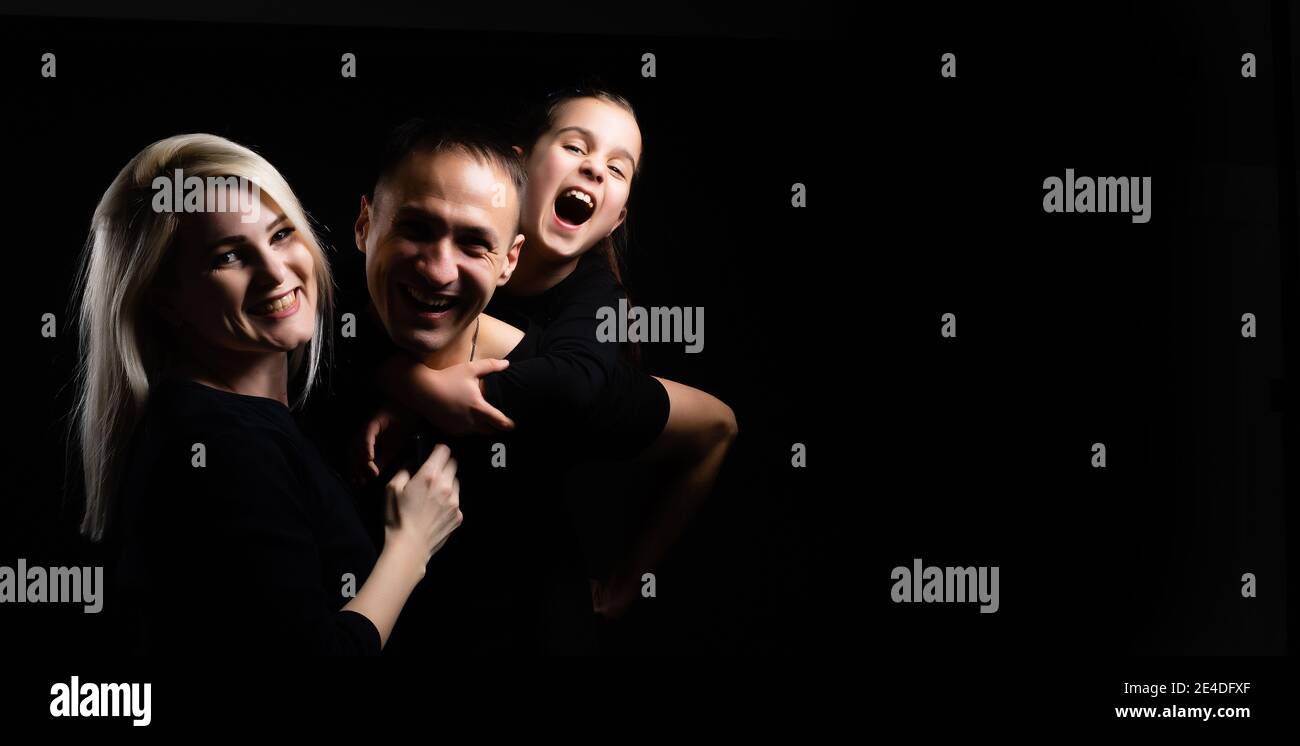 Family portrait on black background Stock Photo - Alamy