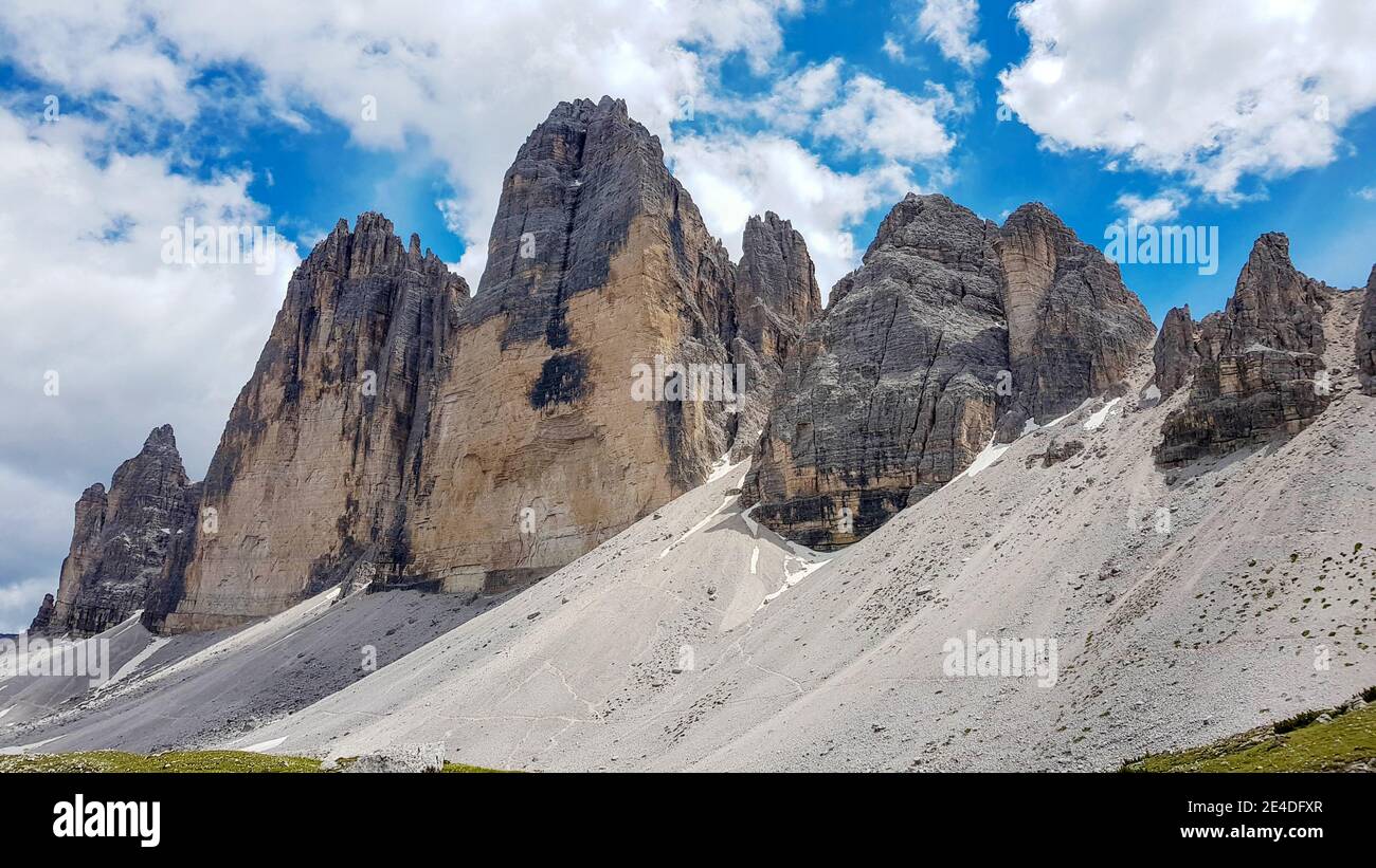 Breathtaking mountain peaks by the grass-covered meadows captured on a ...
