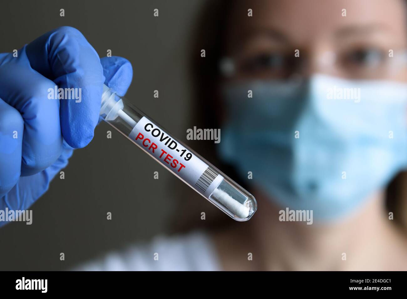 Coronavirus PCR test tube in doctor hand, woman in face mask holds ...