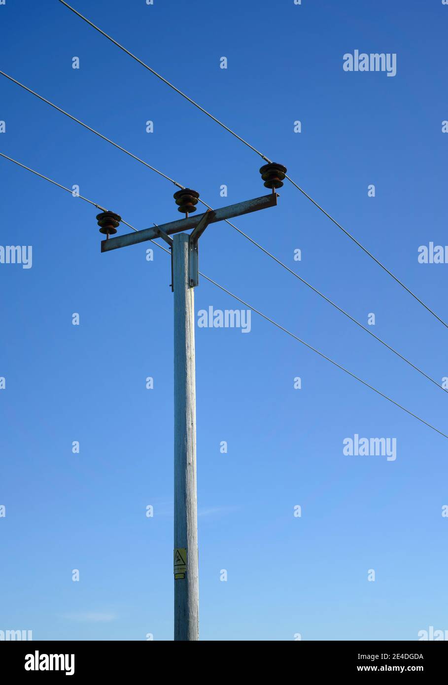 High voltage electricity power cables and support pylon set against a ...