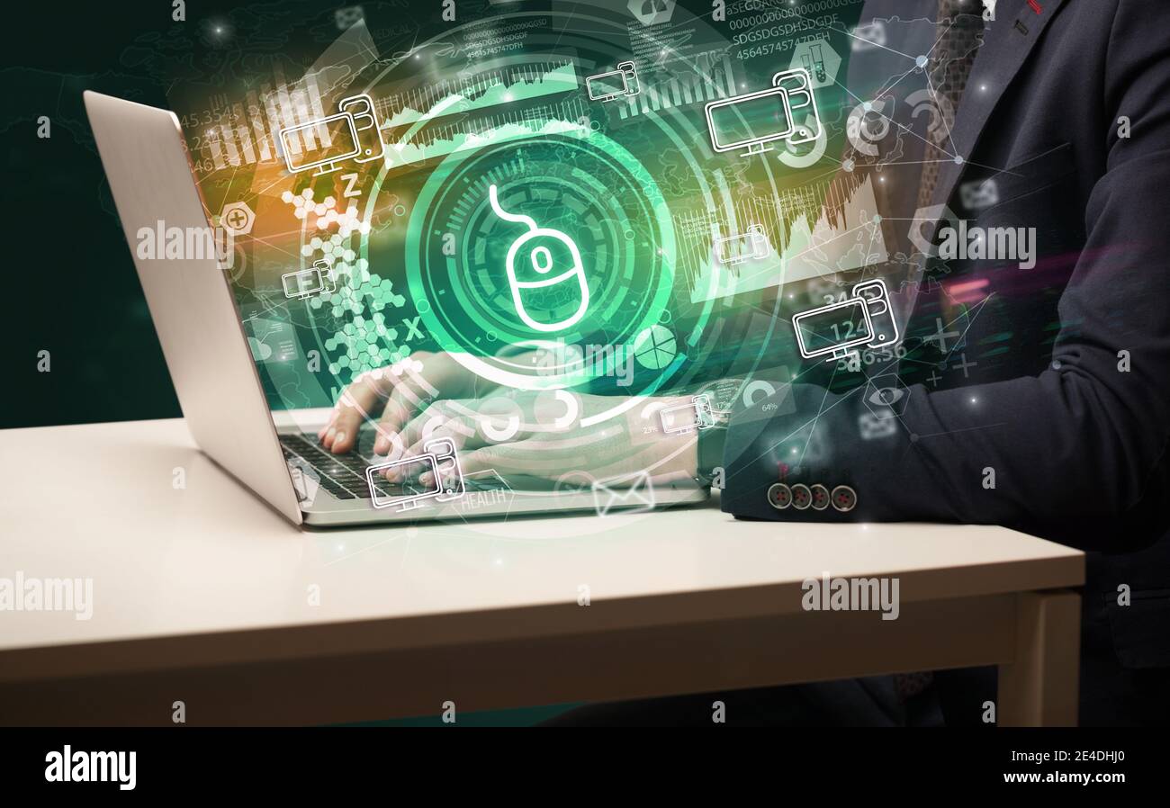 Business hand typing on a modern laptop with mouse icon coming out from ...